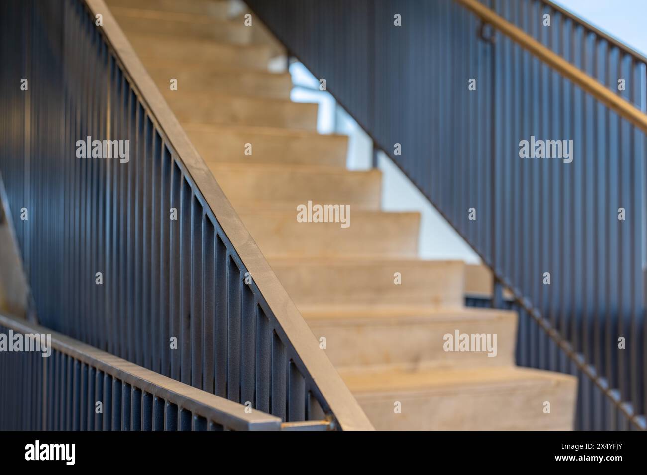 Close-up photo of a modern gray metal railing and concrete stair case ...
