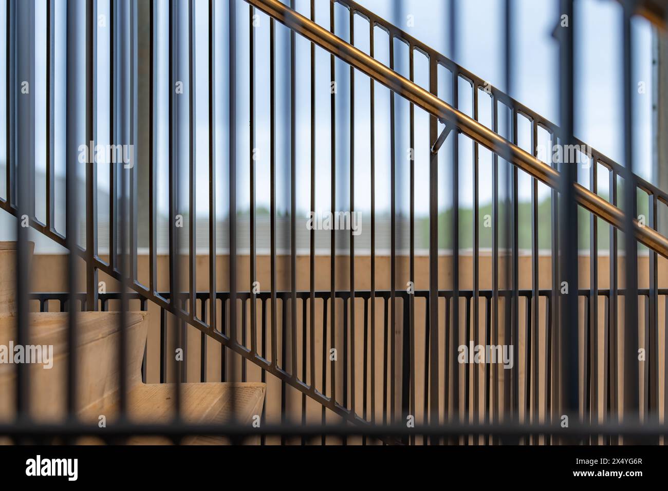 Close-up photo of a modern gray metal railing and concrete stair case ...