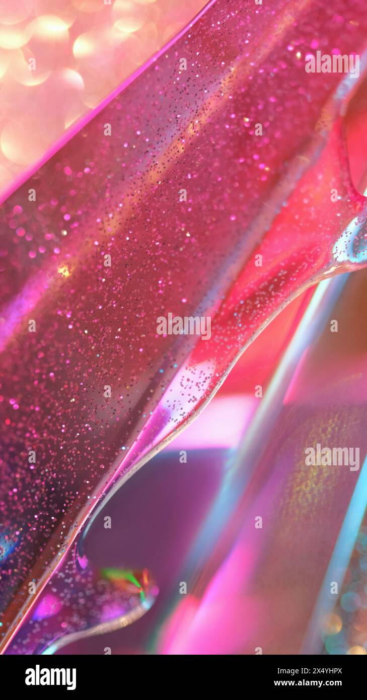 Color sparkles. Shiny overflows. Pink liquid lights on glass oil ...