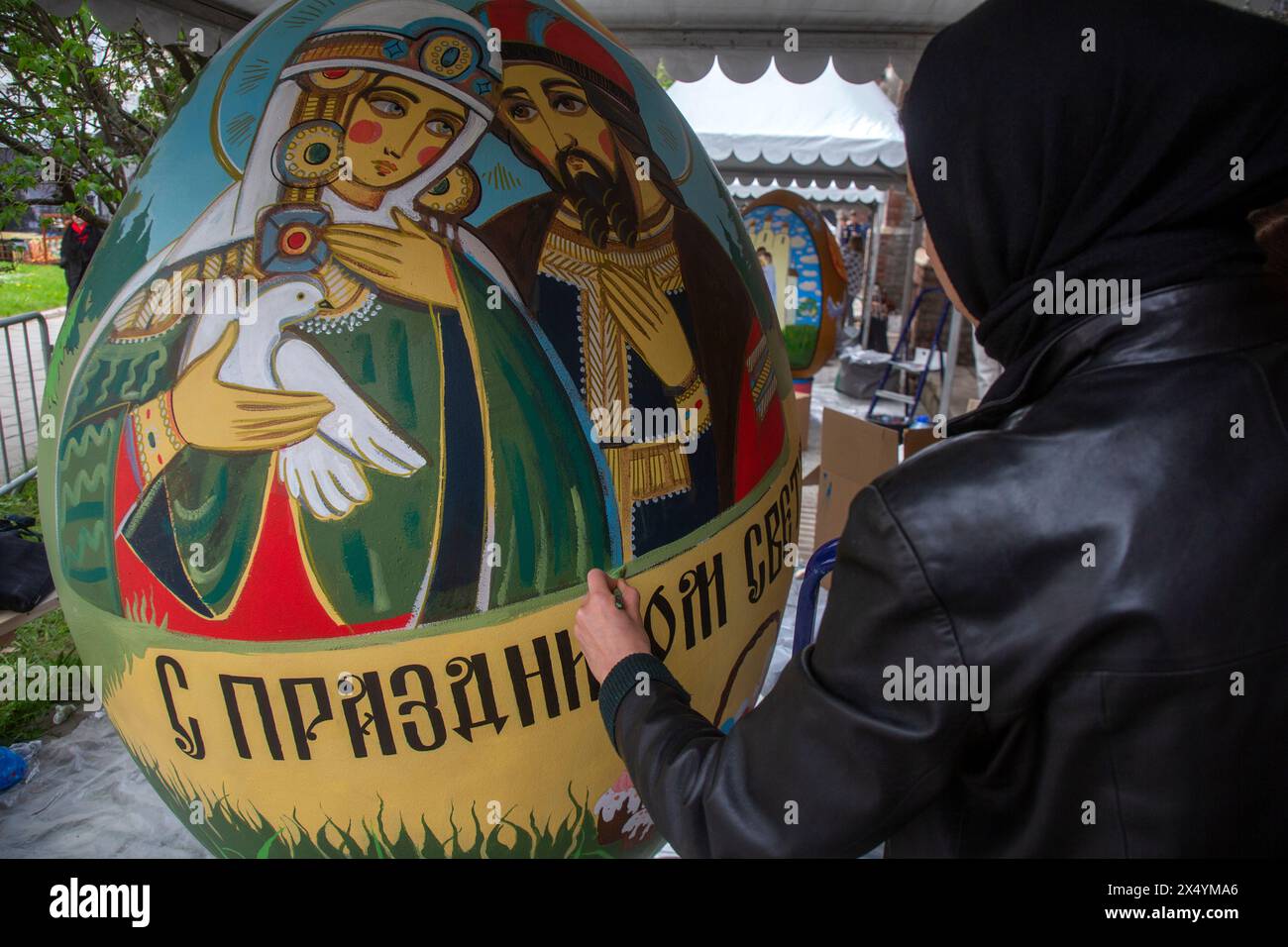 Moscow, Russia. 5th May, 2024. Young artists paint giant Easter eggs ...