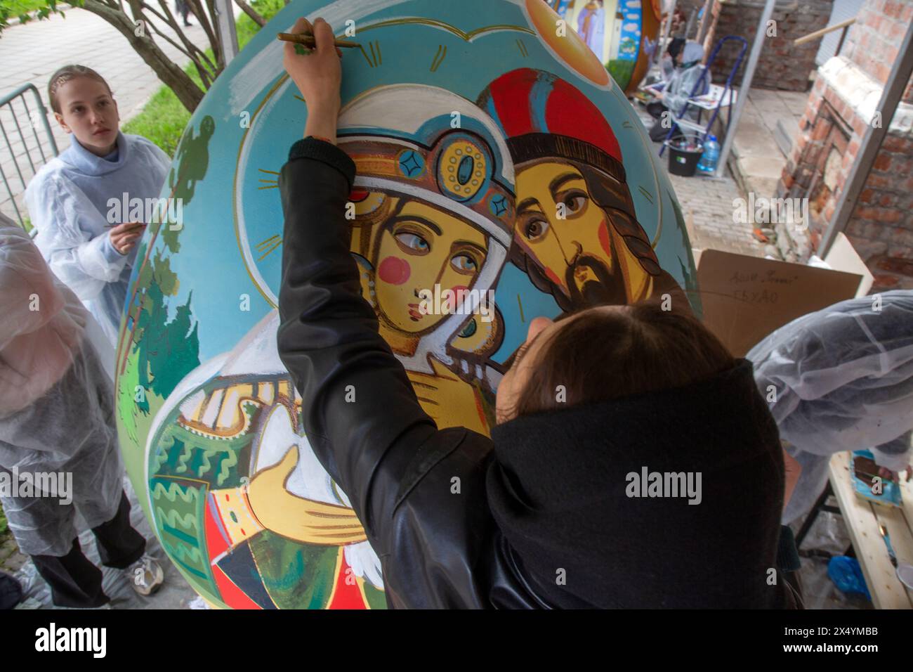 Moscow, Russia. 5th May, 2024. Young artists paint giant Easter eggs ...