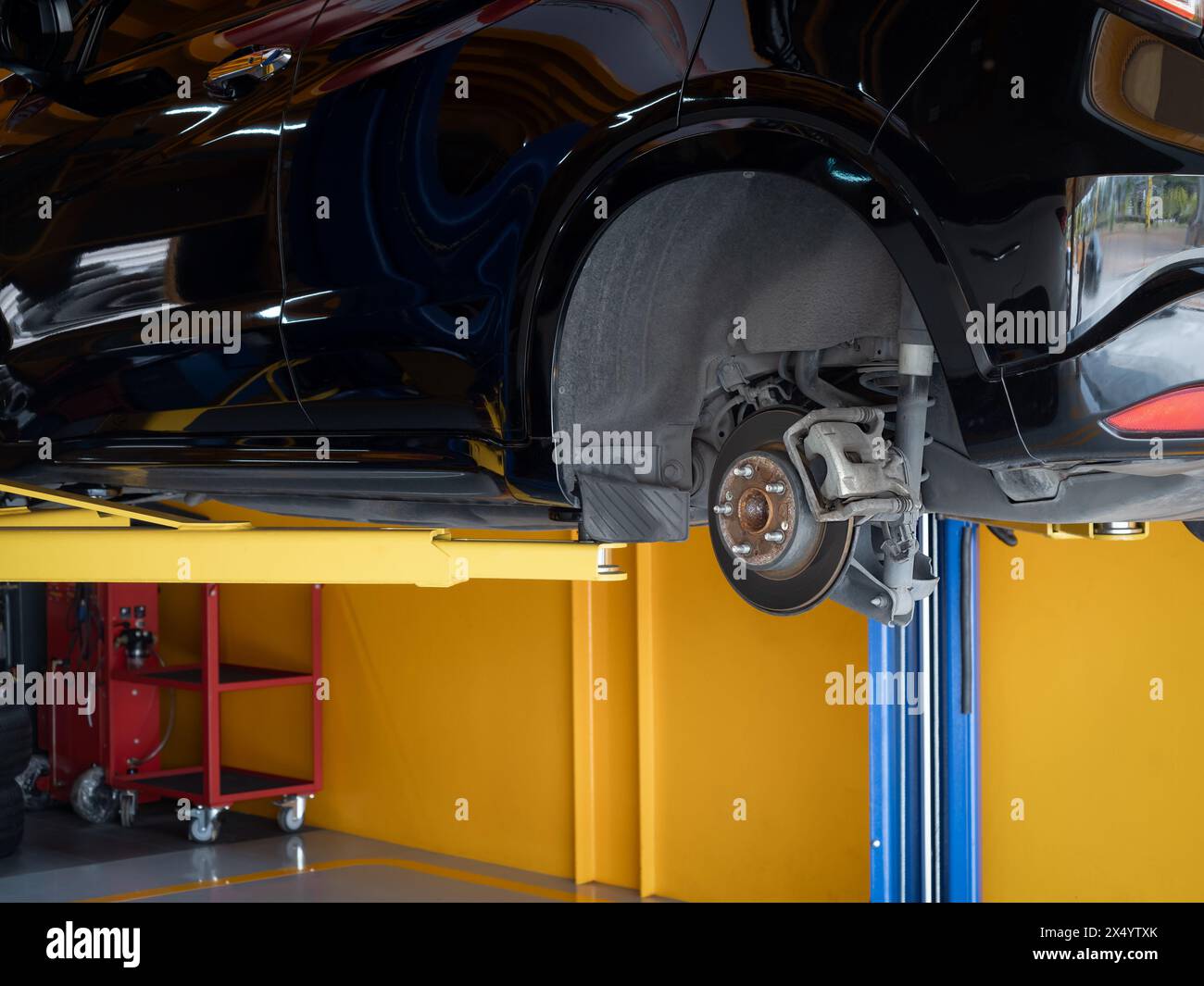 Close-up brake disc without wheels in black sedan car wait for change ...