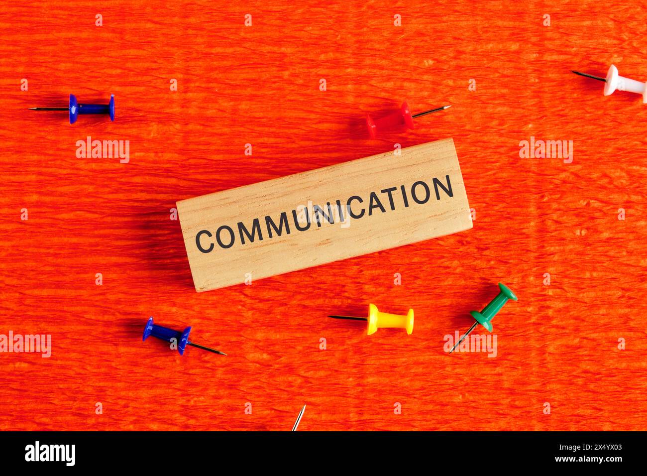 COMMUNICATION word written on wooden blocks on a red background ...