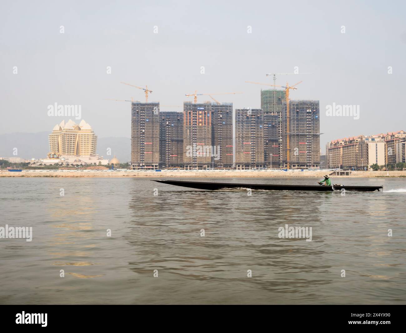 Van Pak Len, Laos - 28 March 2024: A ship is passing by residential ...