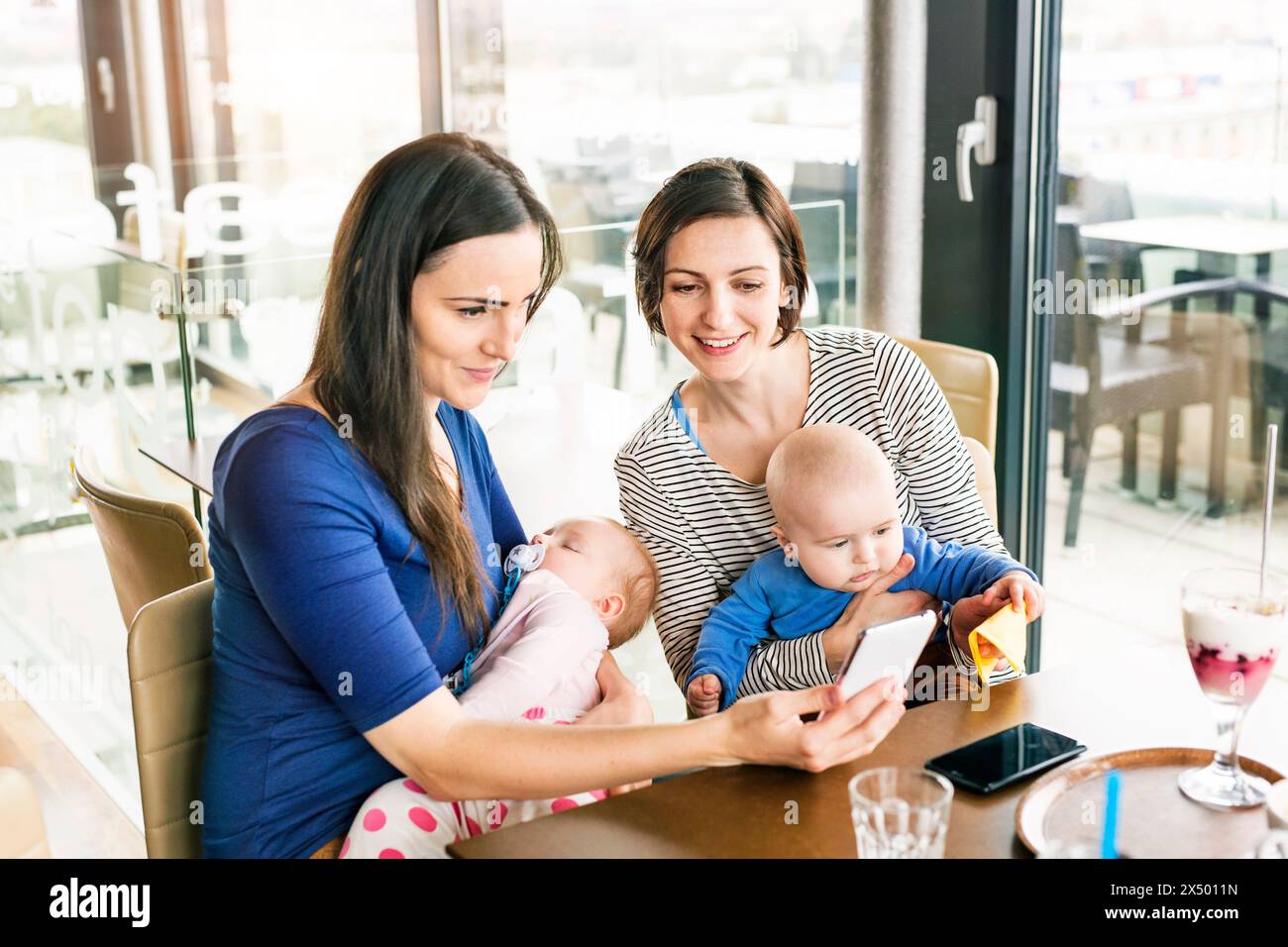 New mom friends going to cafe with babies. Spending free time during ...