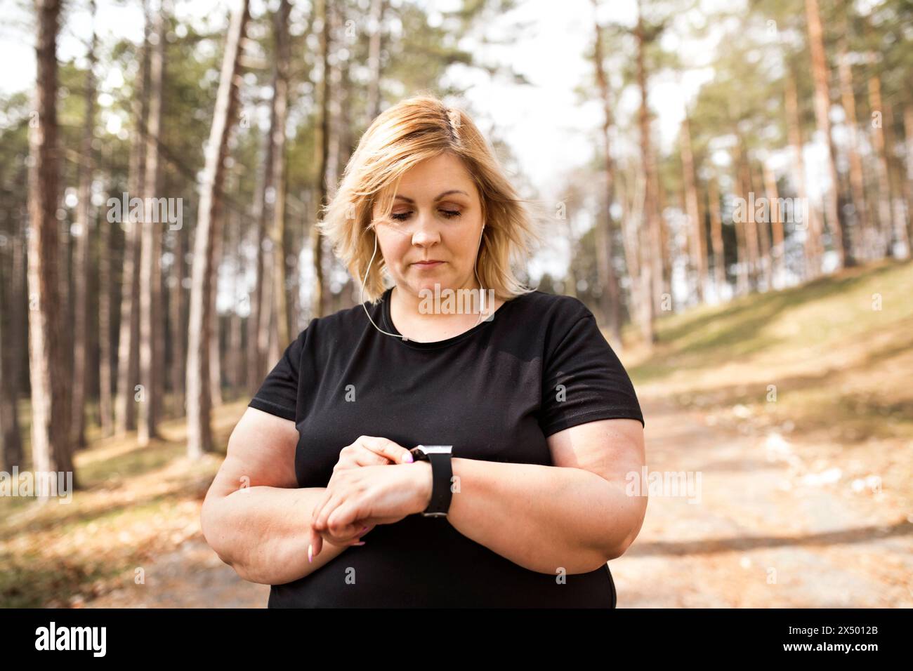 Overweight woman preparing for run in nature. Exercising outdoors for ...