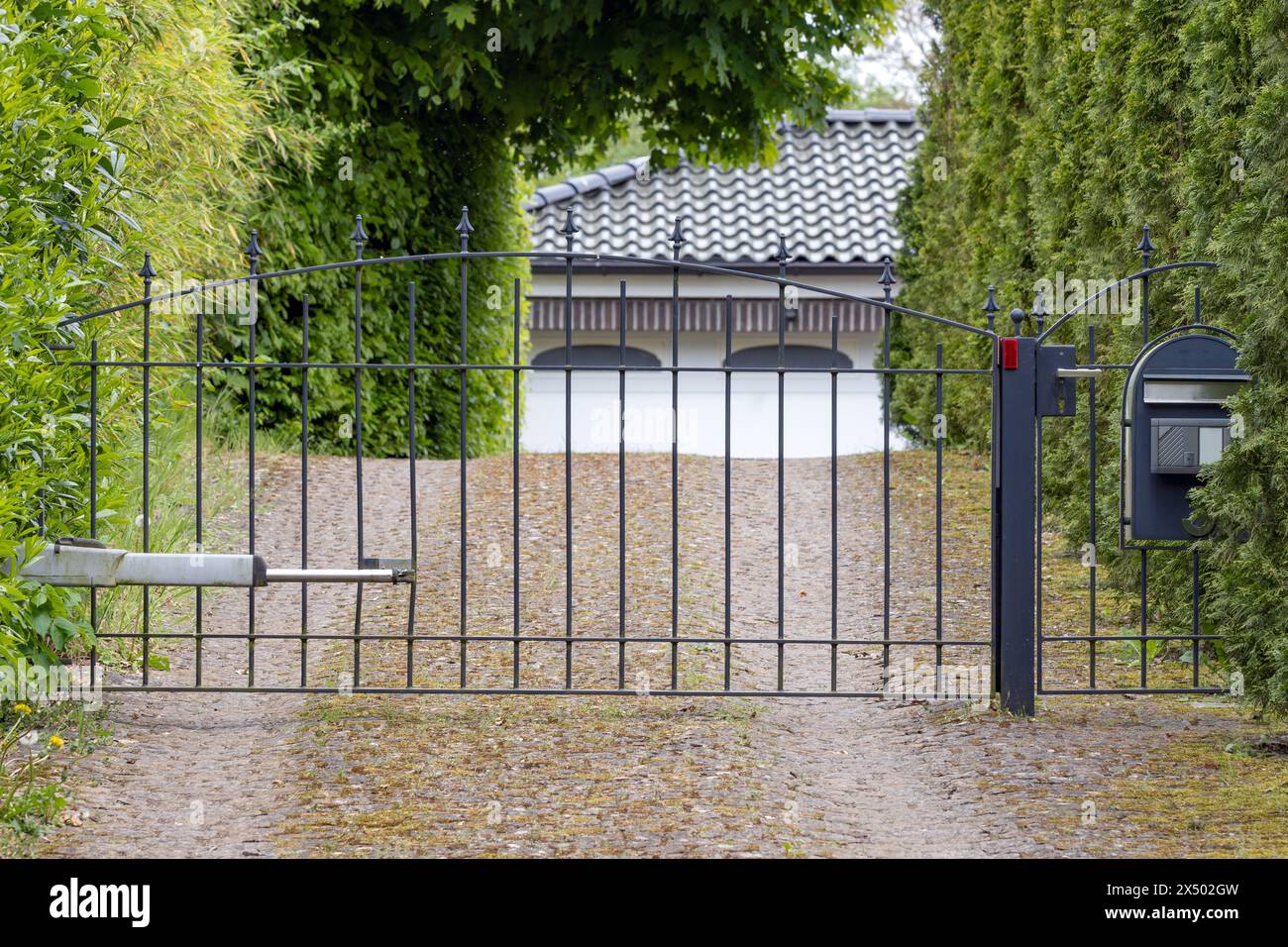 Electric garden gate in the property entrance Stock Photo - Alamy