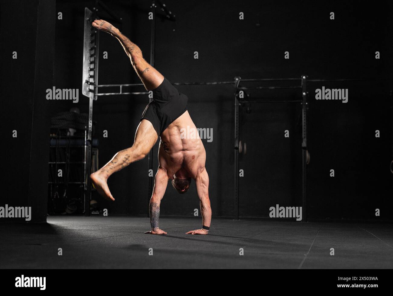 Rear view of handstand exercise, handstand push-ups. Routine workout ...