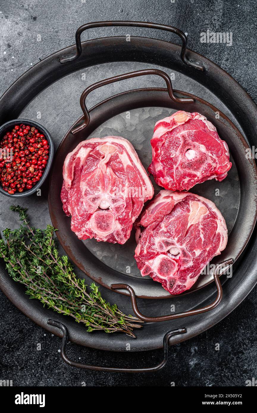 Raw lamb neck meat with bone on a steel tray. Black background. Top ...