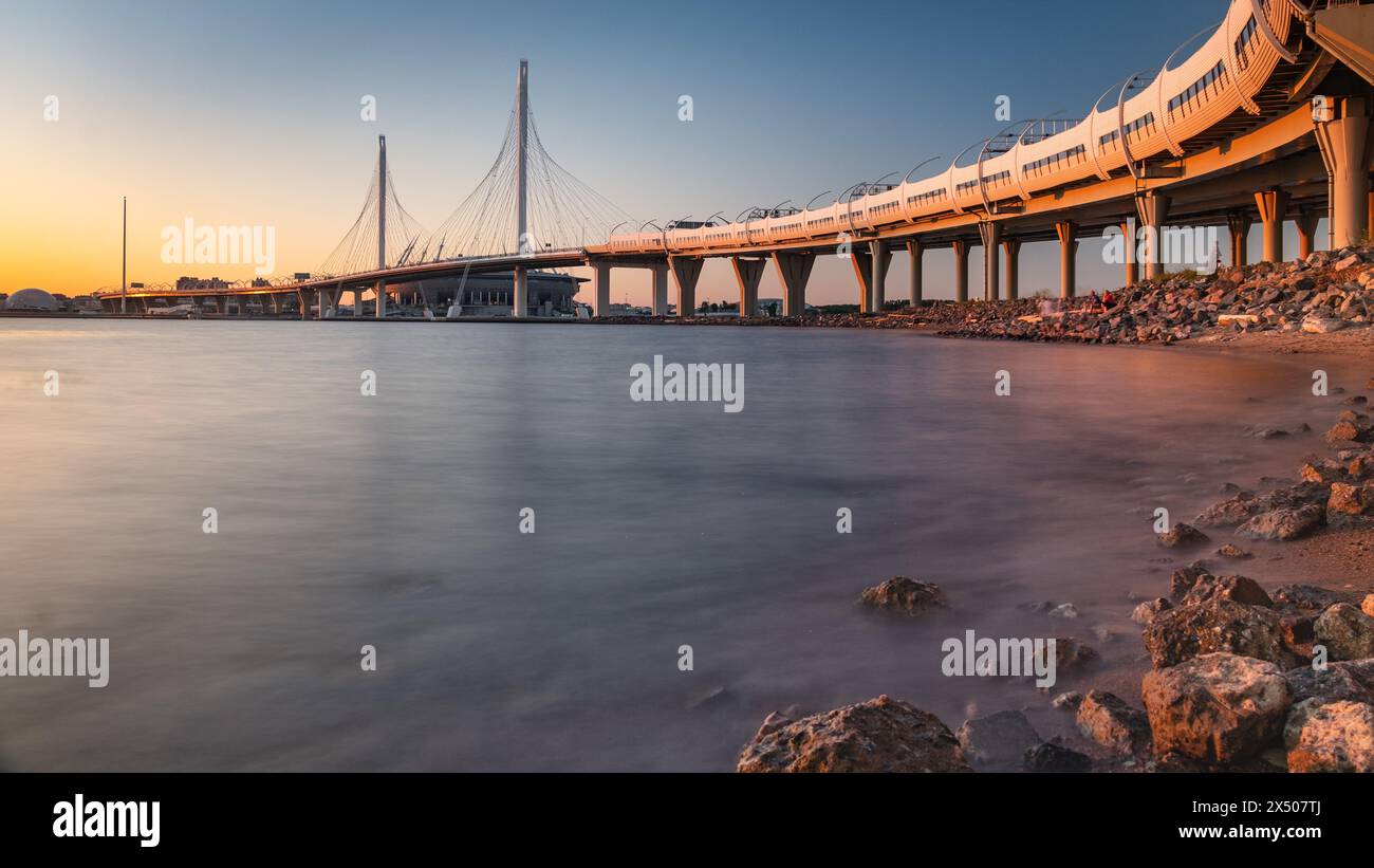 Stunning sunset illuminates a modern cable-stayed bridge, captured over ...