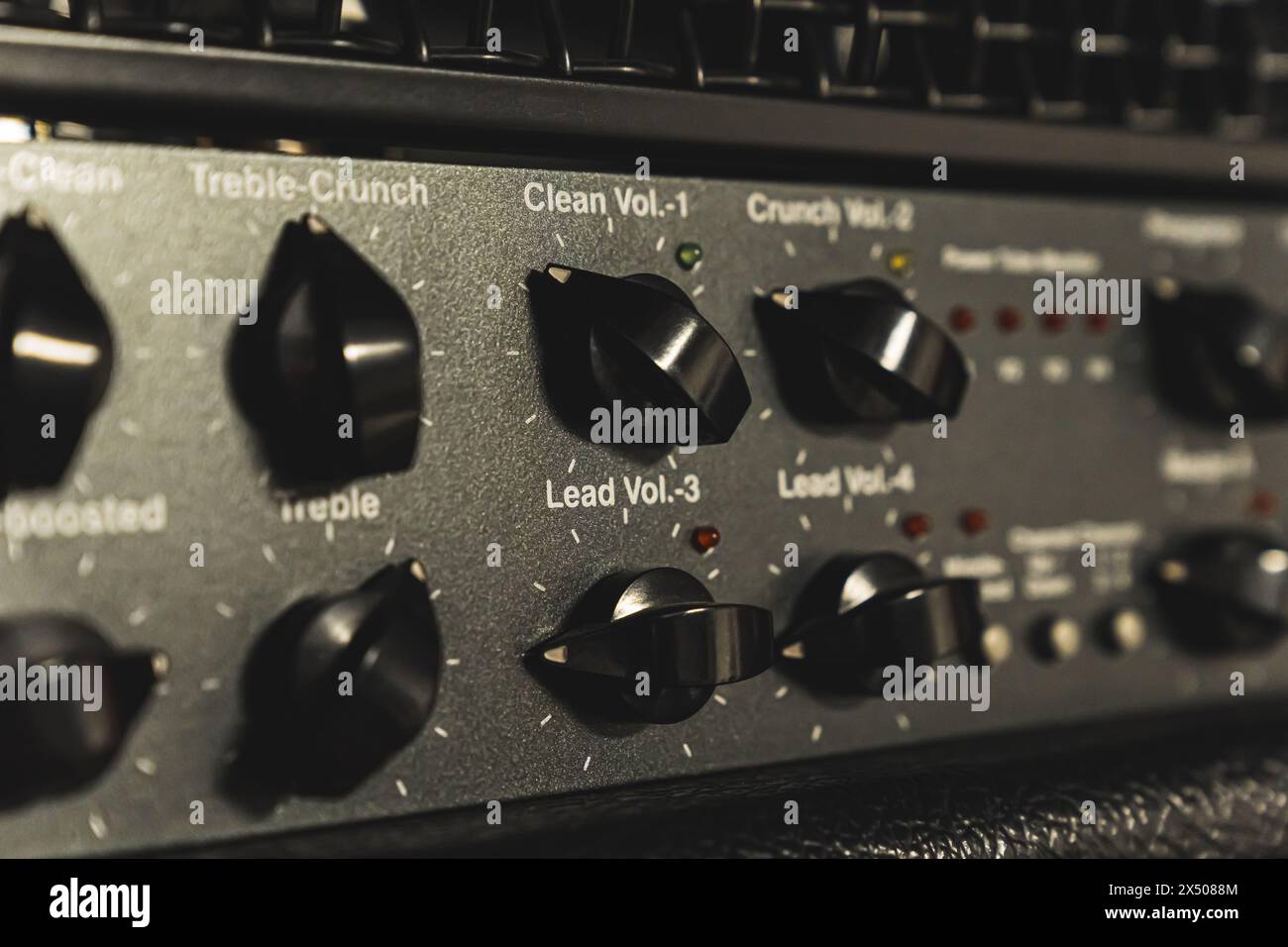 closeup of an electric guitar amplifier showing the knobs. High quality ...