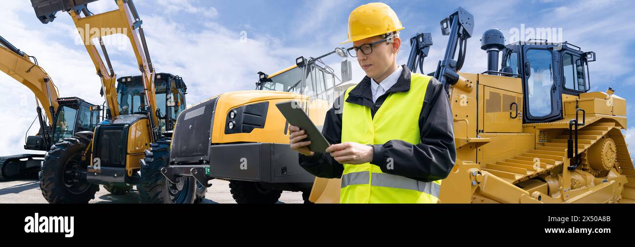 Man controls fleet of yellow construction machines Stock Photo - Alamy