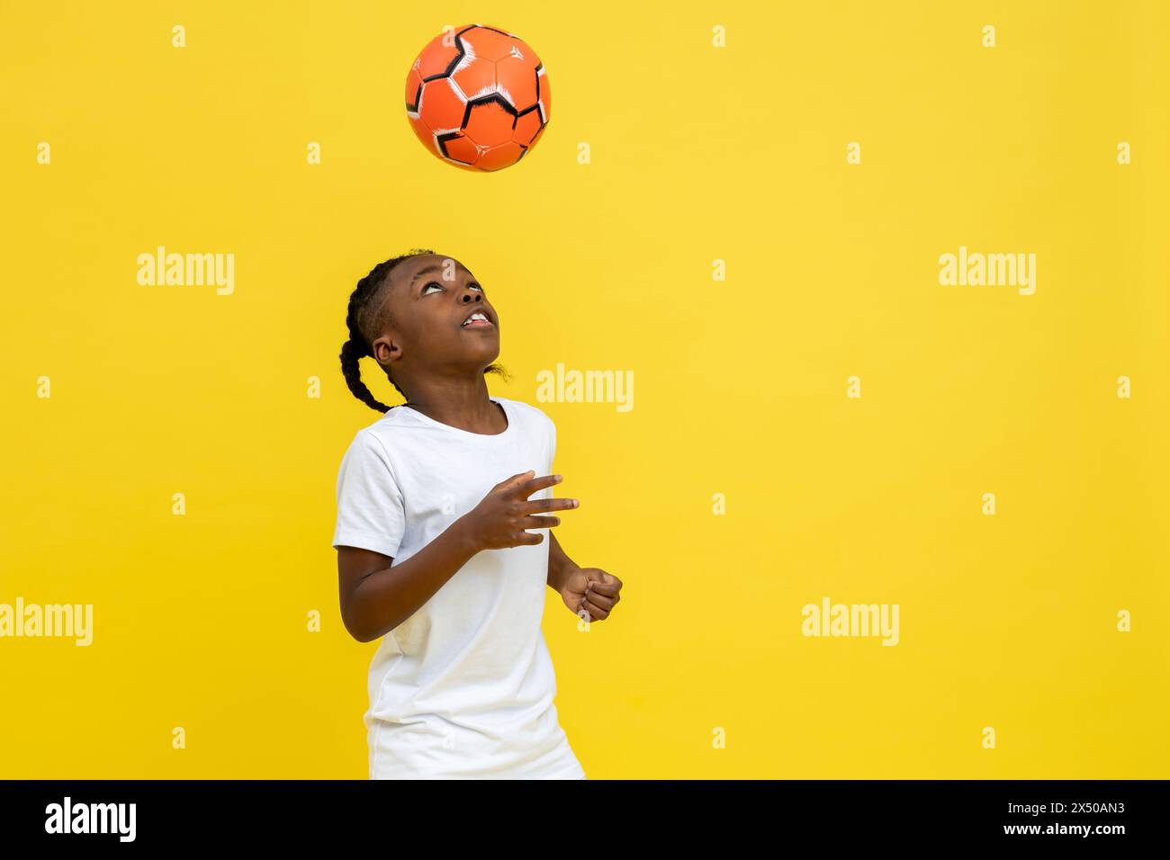 Playful little mixed-race boy doing tricks with soccer ball Stock Photo ...