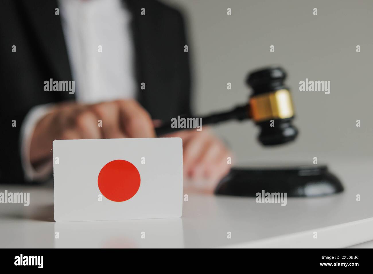 Judge's hand holding gavel. Flag of Japan. Concept of Japanese justice ...