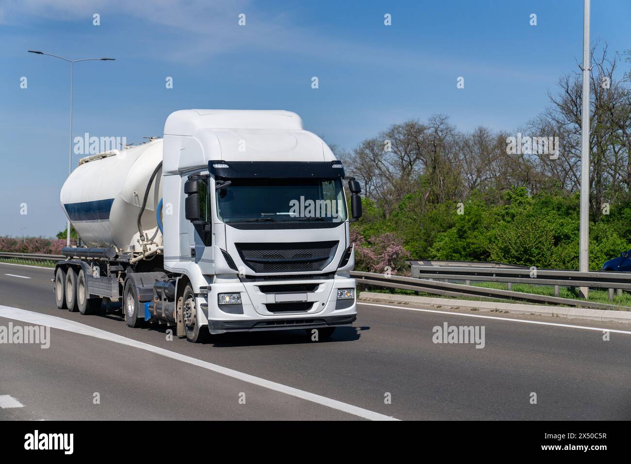Semi truck with tank trailer on the highway Stock Photo - Alamy