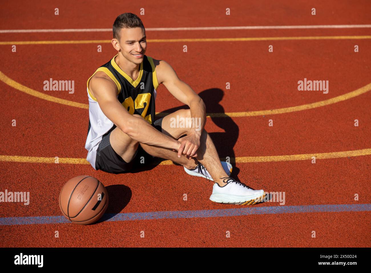 Handsome guy having basketball workout on outdoor summer playground ...
