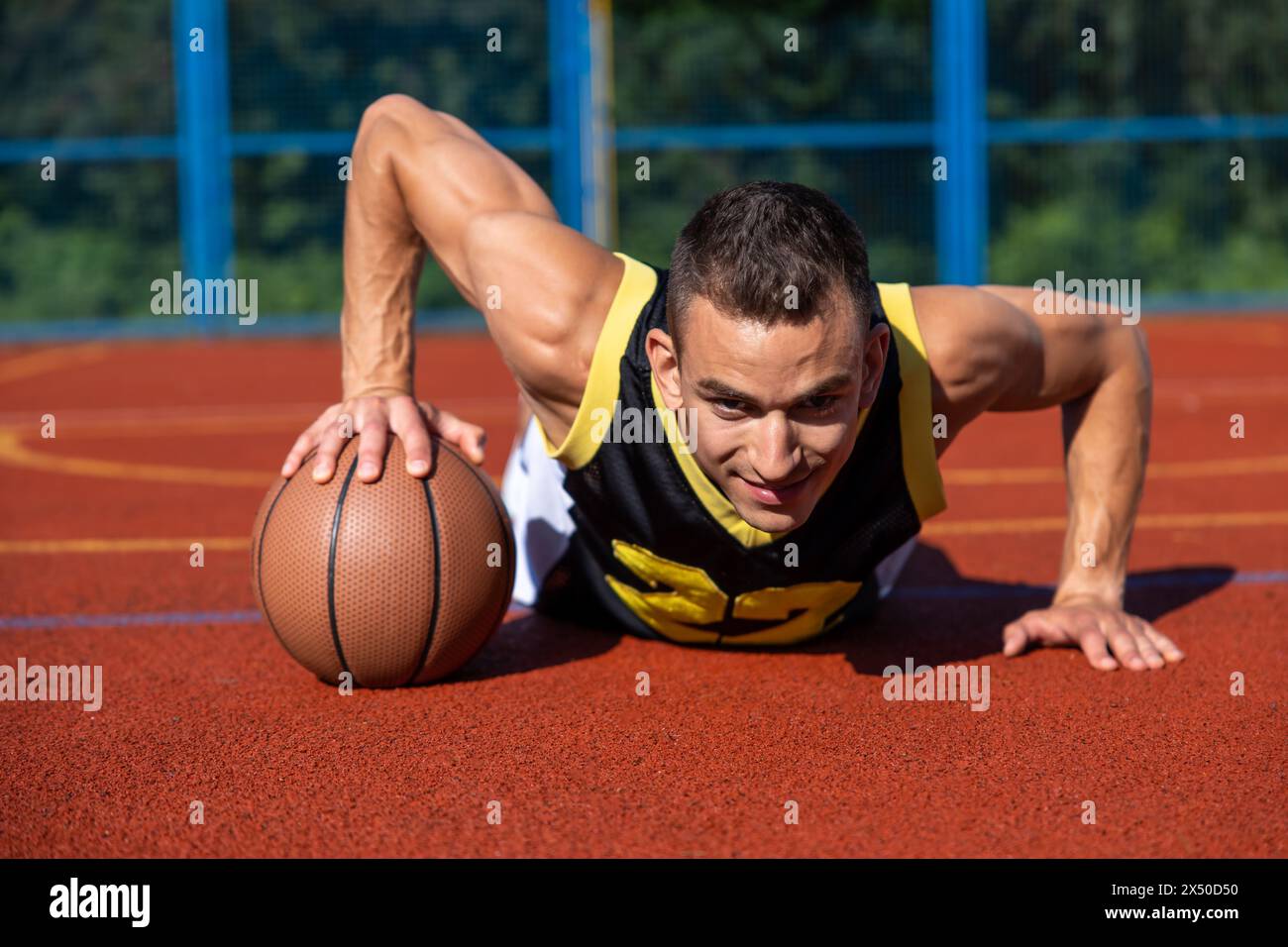 Handsome guy having basketball workout on outdoor summer playground ...
