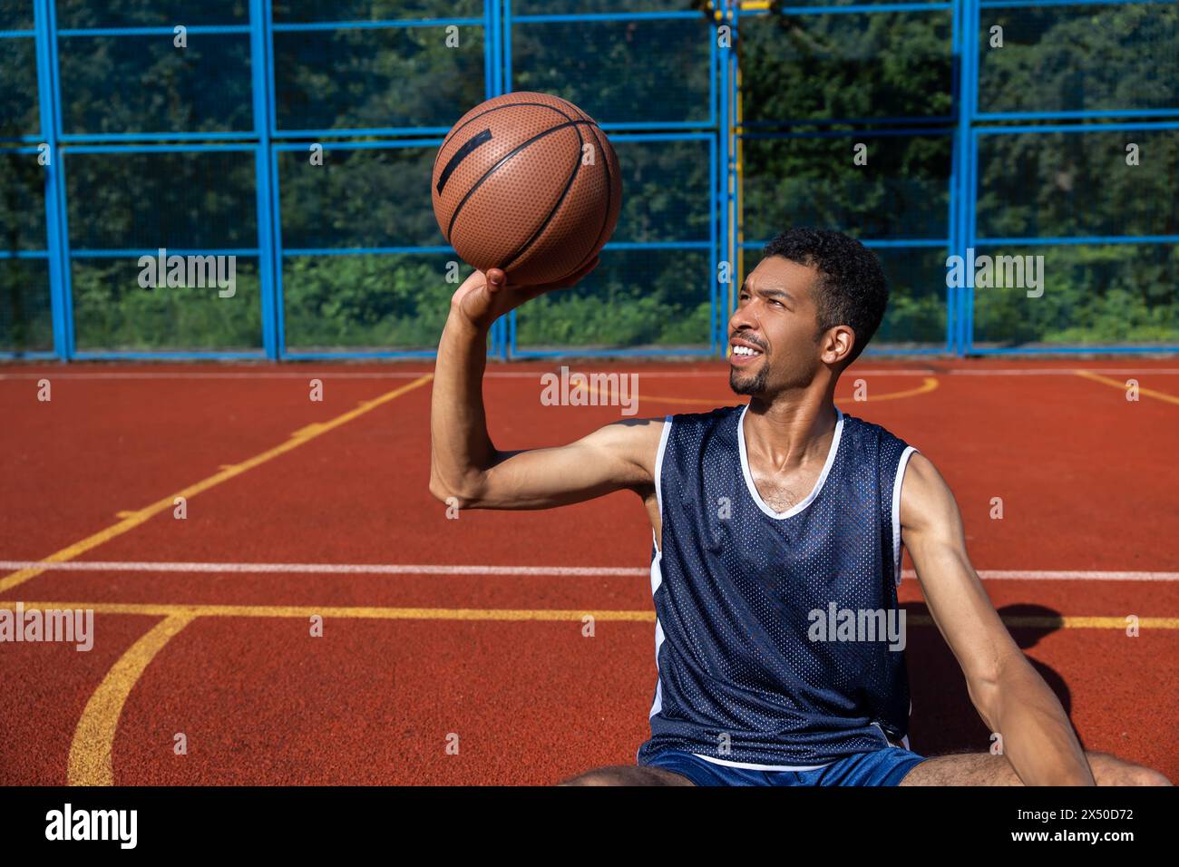 Handsome guy having basketball workout on outdoor summer playground ...