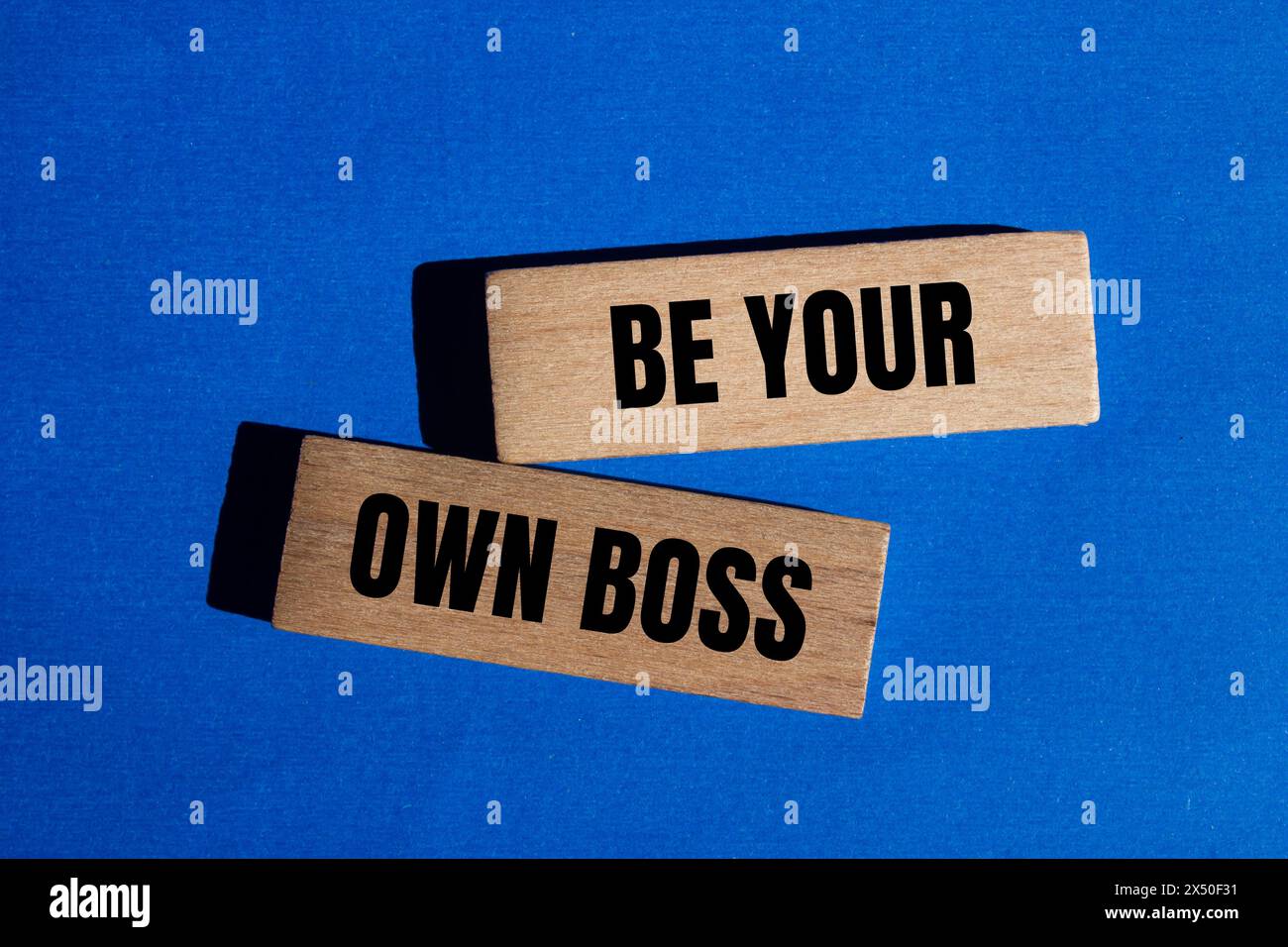 Be your own boss words written on wooden blocks with blue background ...