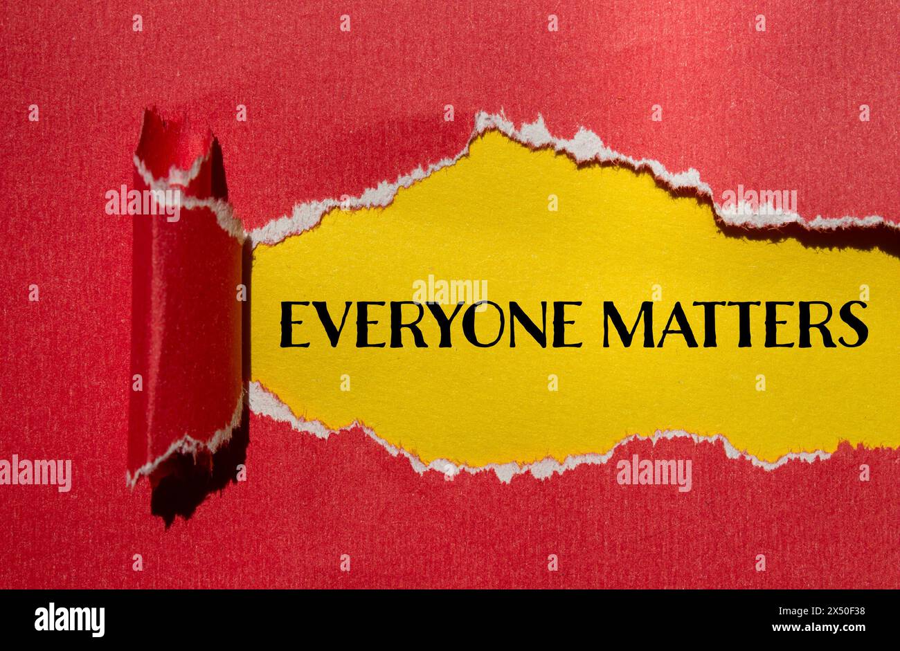Everyone matters words written on ripped red paper with yellow ... Everyone matters words written on ripped red paper with yellow ...