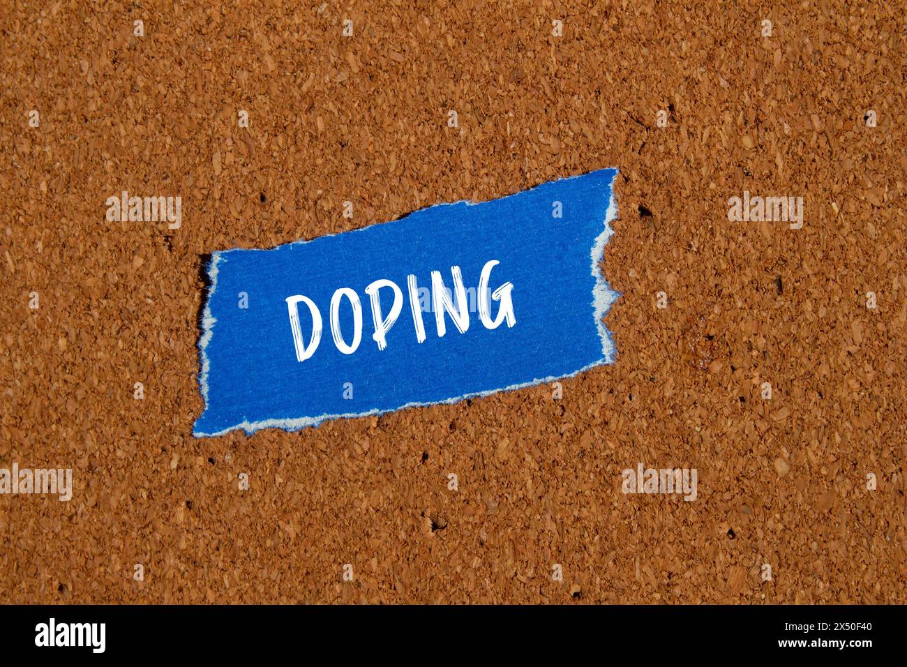 Doping word written on ripped blue paper piece with brown background ... Doping word written on ripped blue paper piece with brown background ...