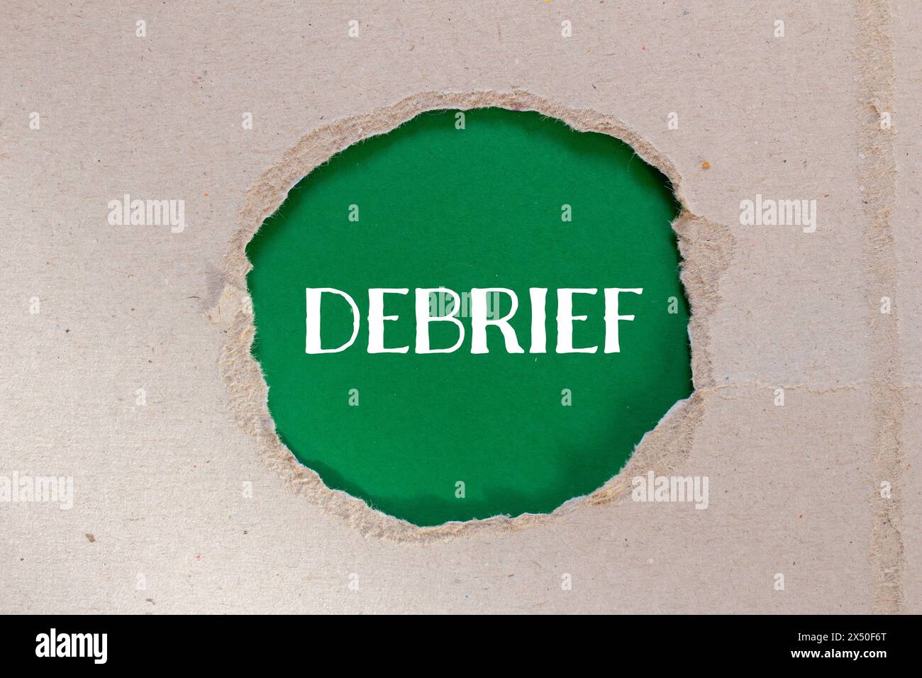 Debrief word written on ripped paper with green background. Conceptual ...