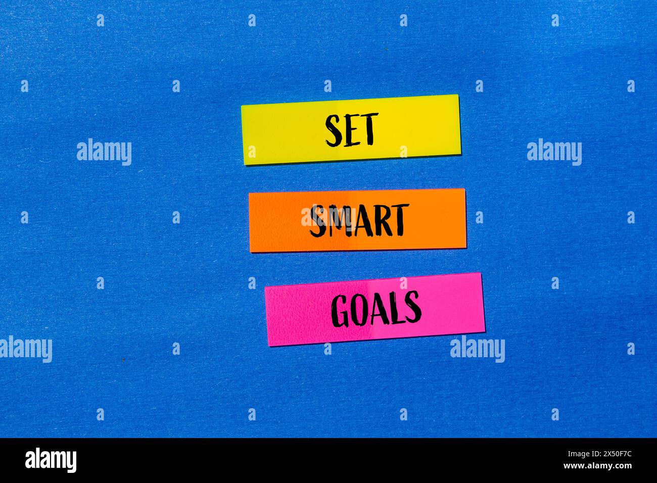 Set smart goals written on colorful paper stickers with blue background ...