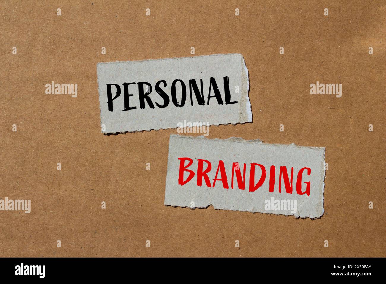 Personal branding words written on ripped paper pieces with brown ...