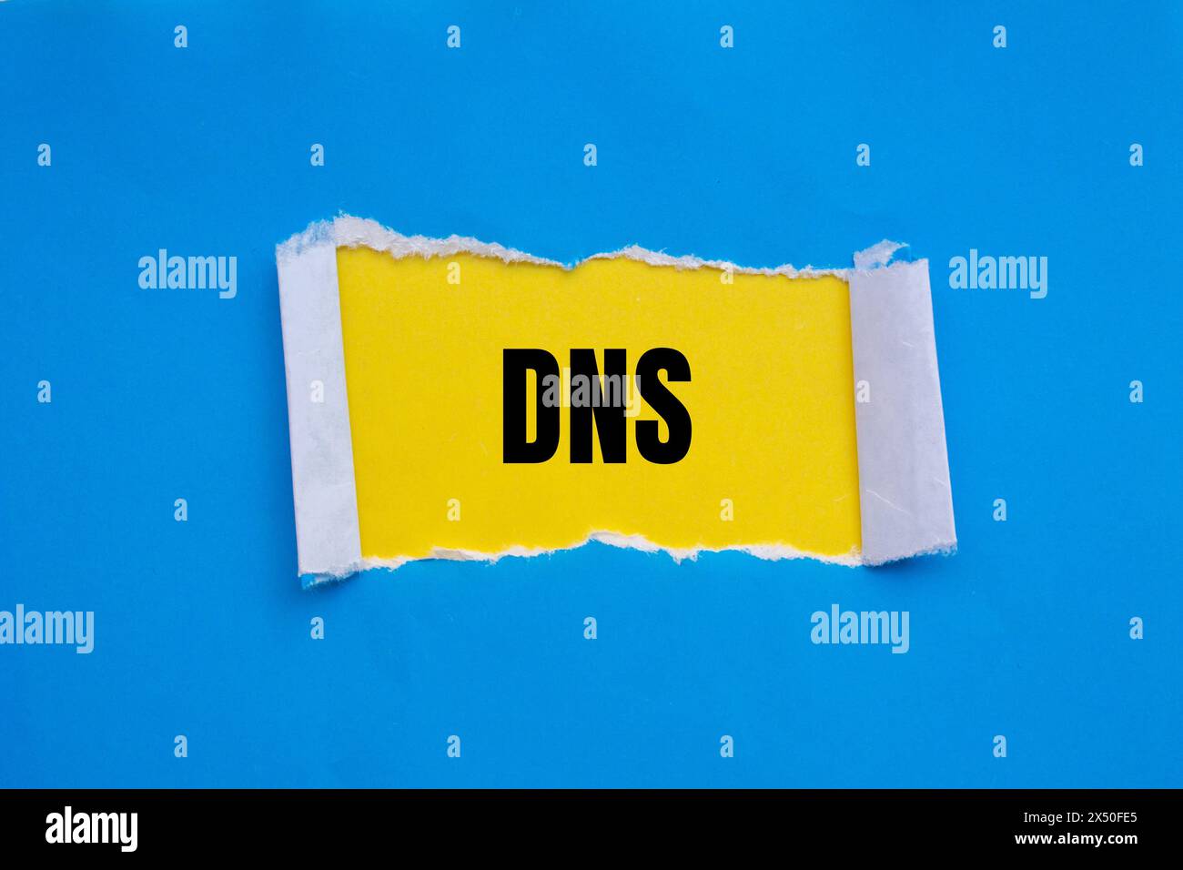 DNS word written on ripped blue paper with yellow background ...