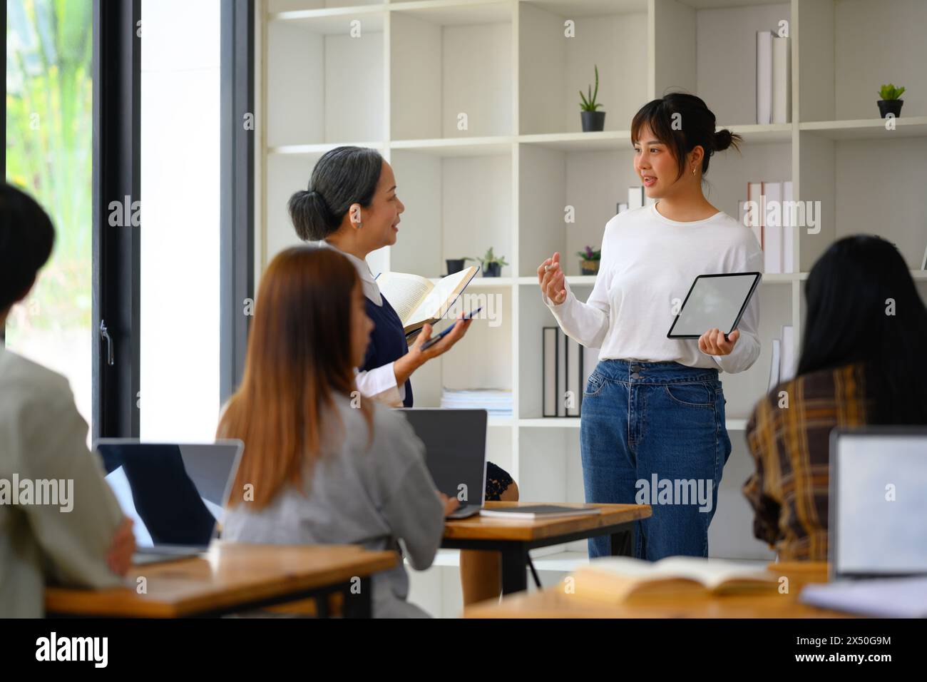 Teacher presenting project classroom hi-res stock photography and ...