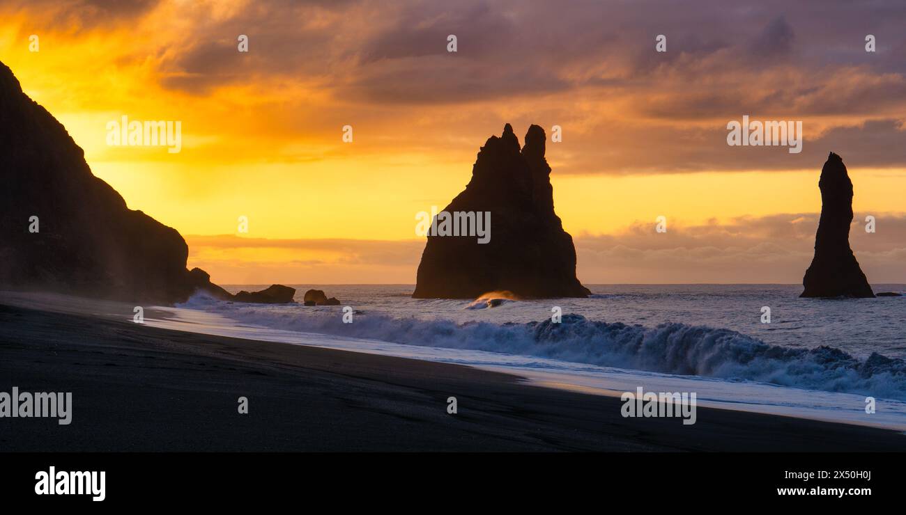 Sunrise silhouette of Reynisdrangar sea stacks from Reynisfjara black ...
