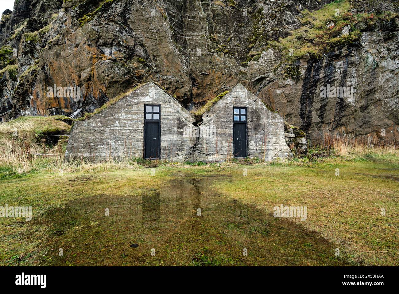 Turf houses at the foot of Drangurinn Rock, Southern Iceland, Iceland ...