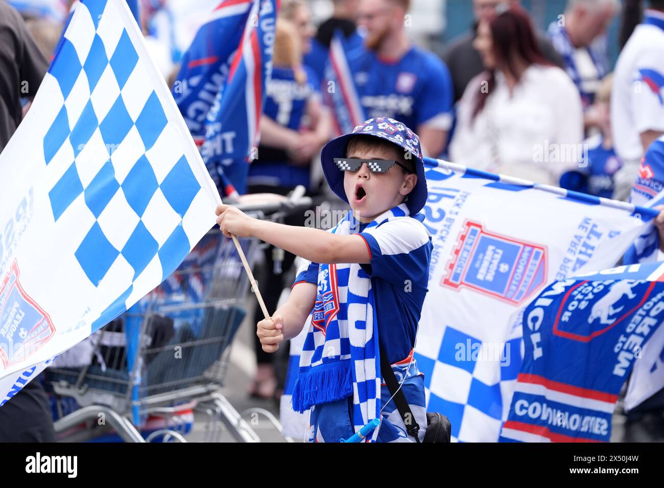 An Ipswich Town fan ahead of an open-top bus parade in Ipswich to ...
