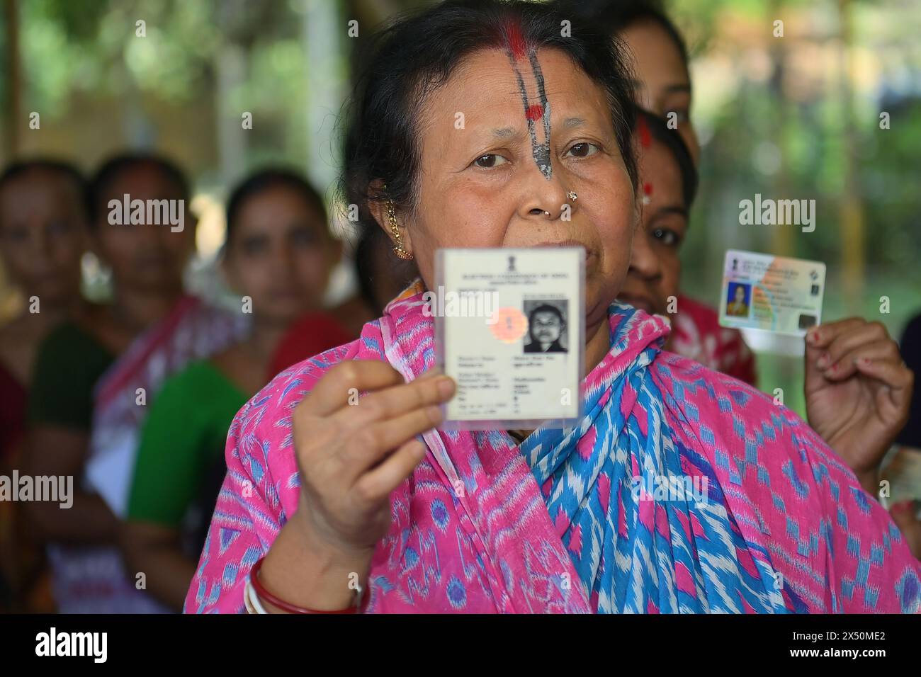 Voters queue up at a Sonamura polling station in Agartala for the Lok ...