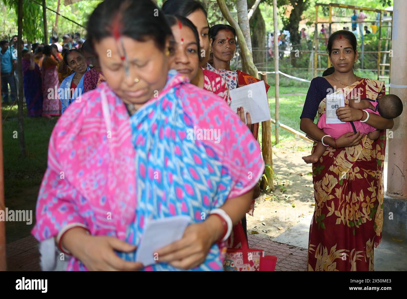 Voters queue up at a Sonamura polling station in Agartala for the Lok ...