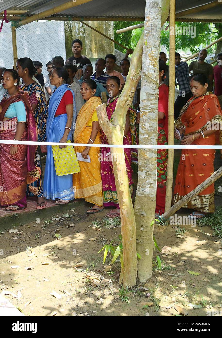 Voters queue up at a Sonamura polling station in Agartala for the Lok ...