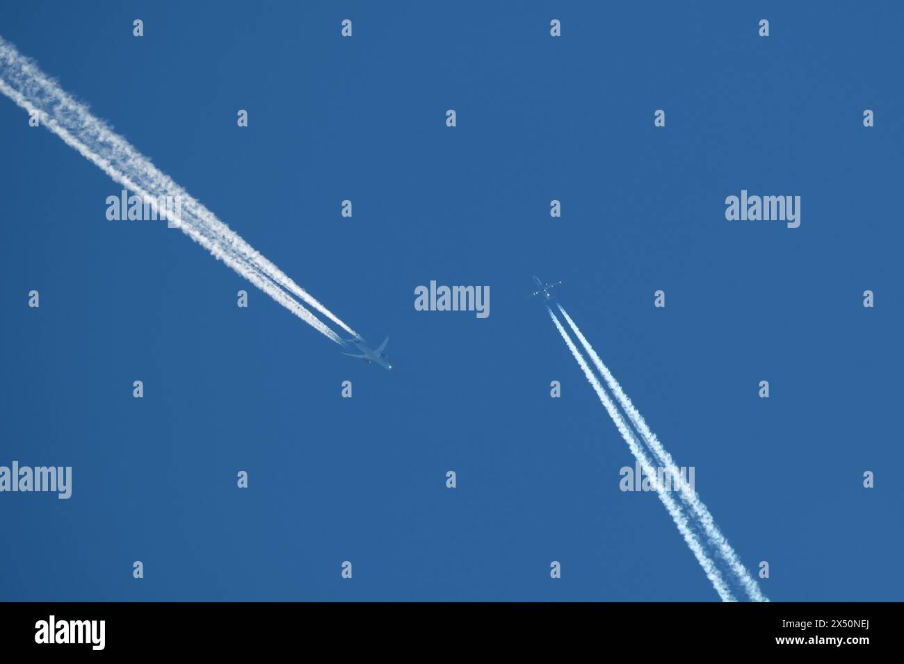 two planes in the sky, two parallel airplane tracks in the blue sky ...