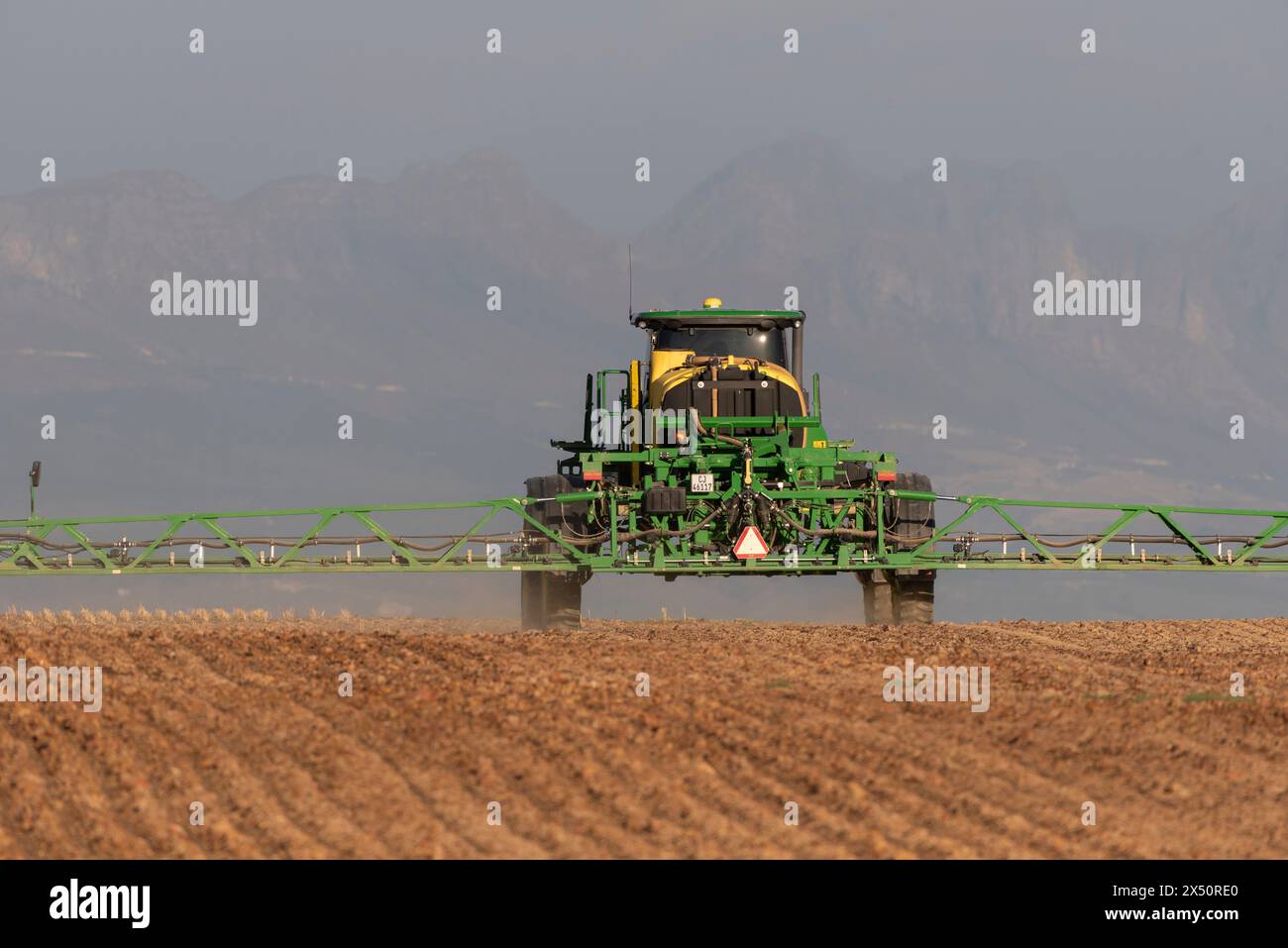 Western Cape, South Africa. 24 th April 2024. Tractor with spray boom ...