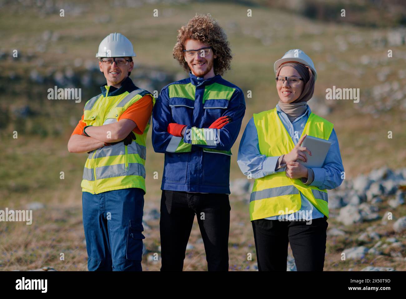 A team of engineers and workers oversees a wind turbine project at a ...