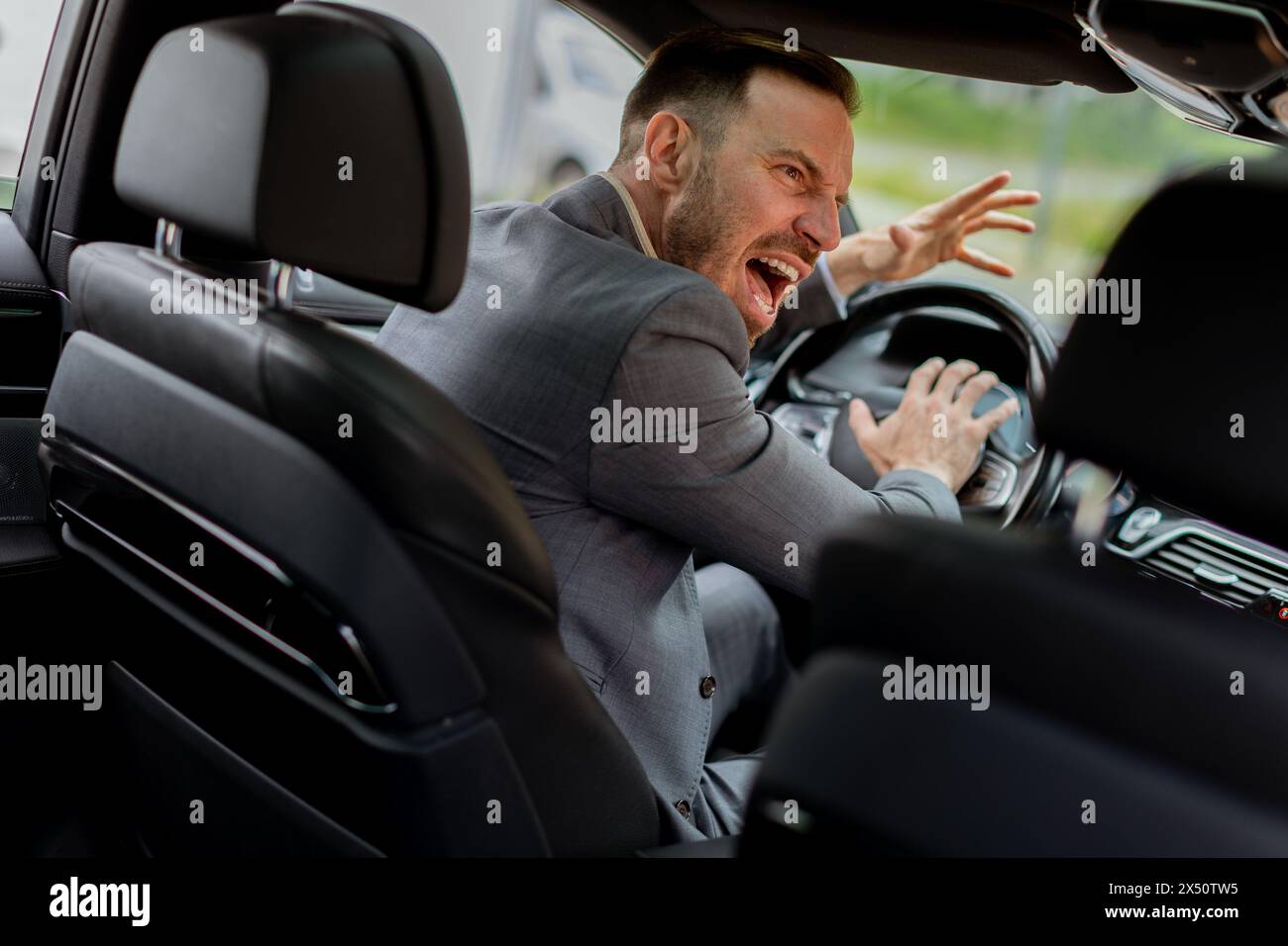 Man in a suit appears to be shouting during traffic jam behind the ...