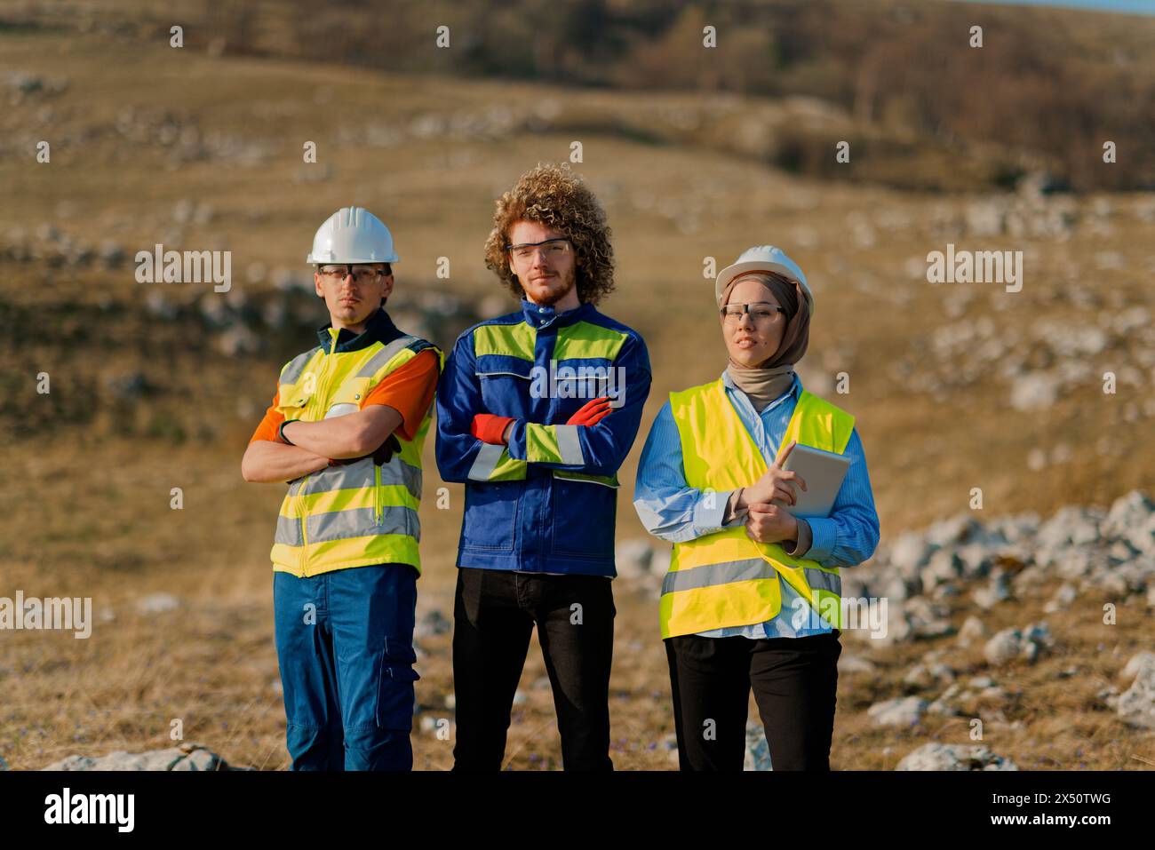 A team of engineers and workers oversees a wind turbine project at a ...