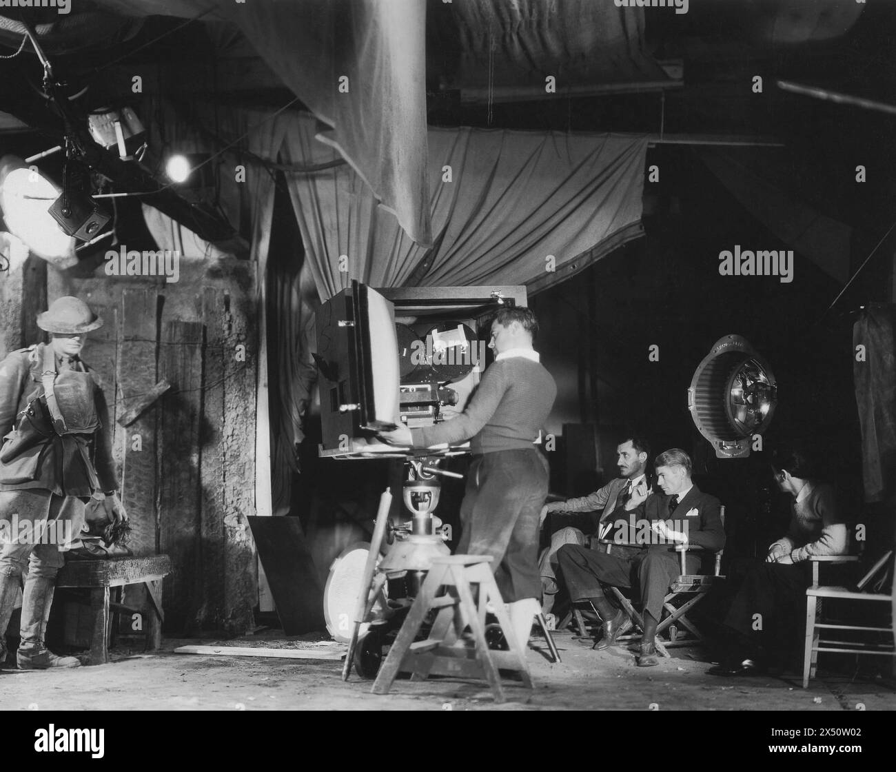 JAMES WHALE directing a scene of COLIN CLIVE walking in to the dugout ...