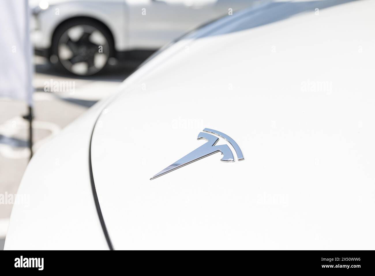 Close up of white Tesla logo on electric vehicle car Stock Photo - Alamy