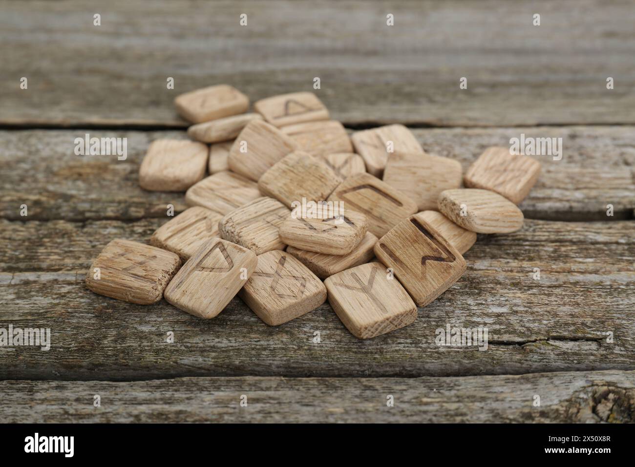 Pile of runes with different symbols on wooden table Stock Photo - Alamy