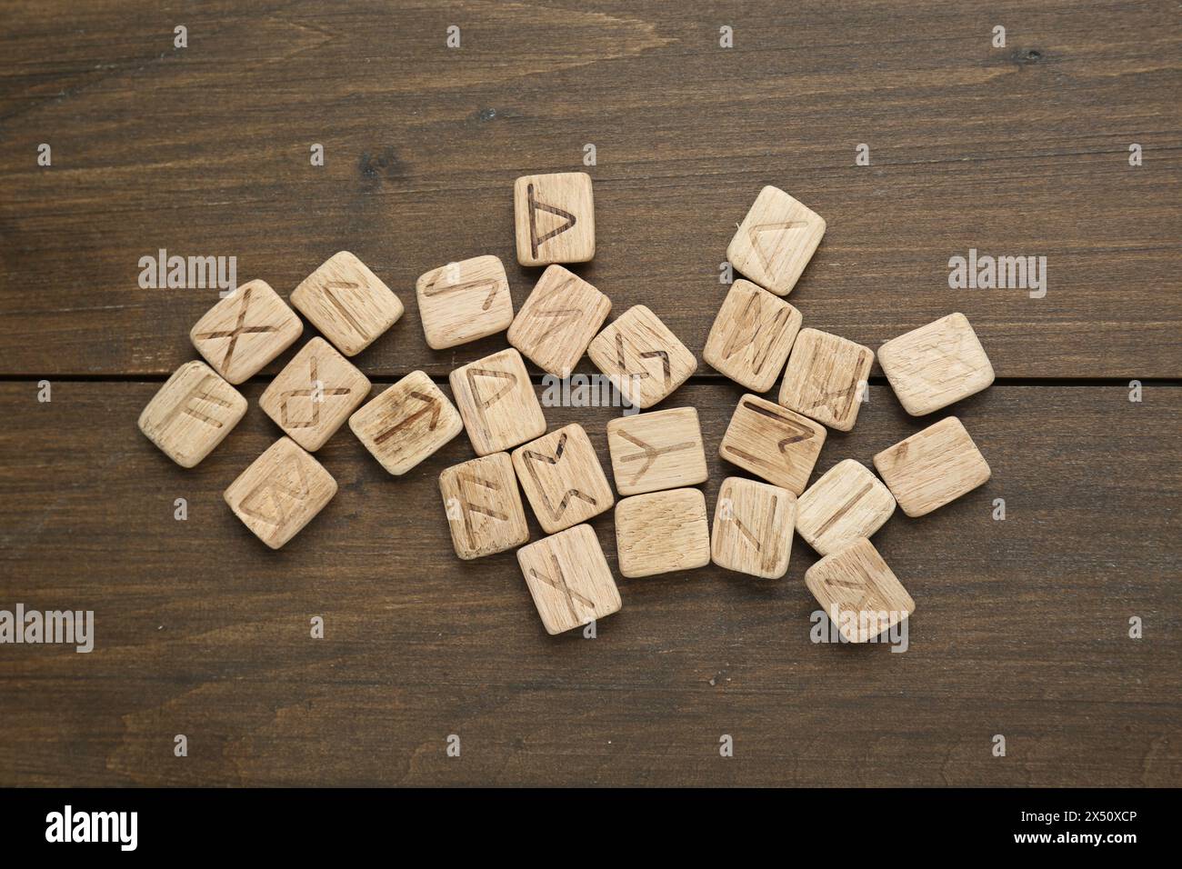 Runes with different symbols on wooden table, flat lay Stock Photo - Alamy