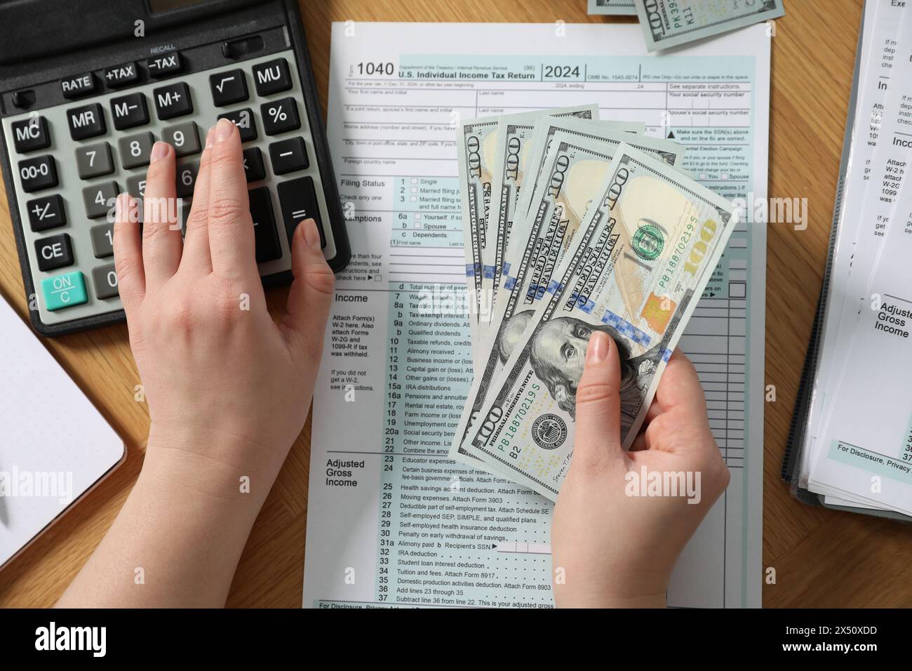 Payroll. Woman with dollar banknotes and calculator planning budget at ...