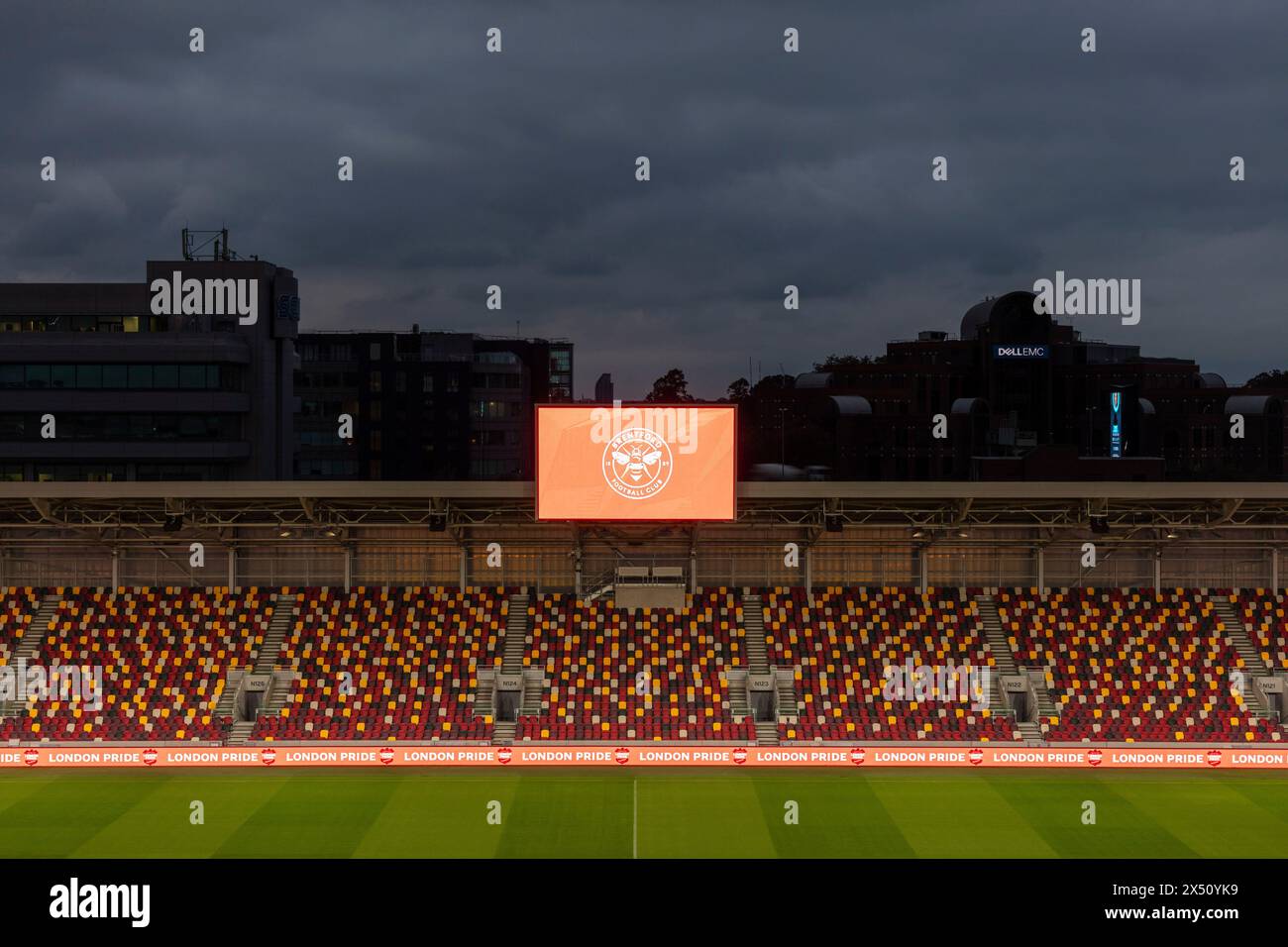 Twilight view across the pitch, showing a large tv screen. Brentford ...