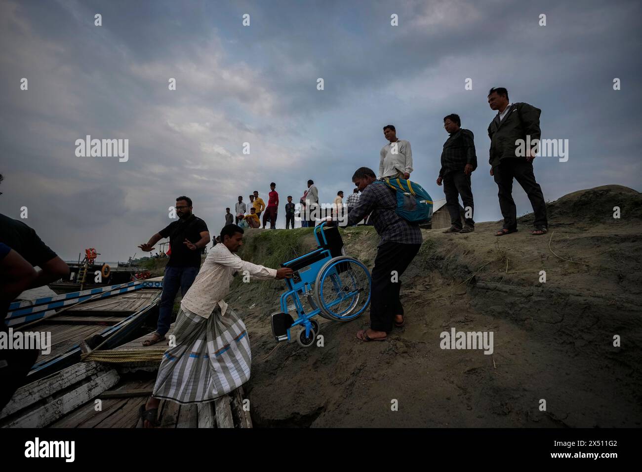 Election officials load a wheelchair for the physically handicapped ...