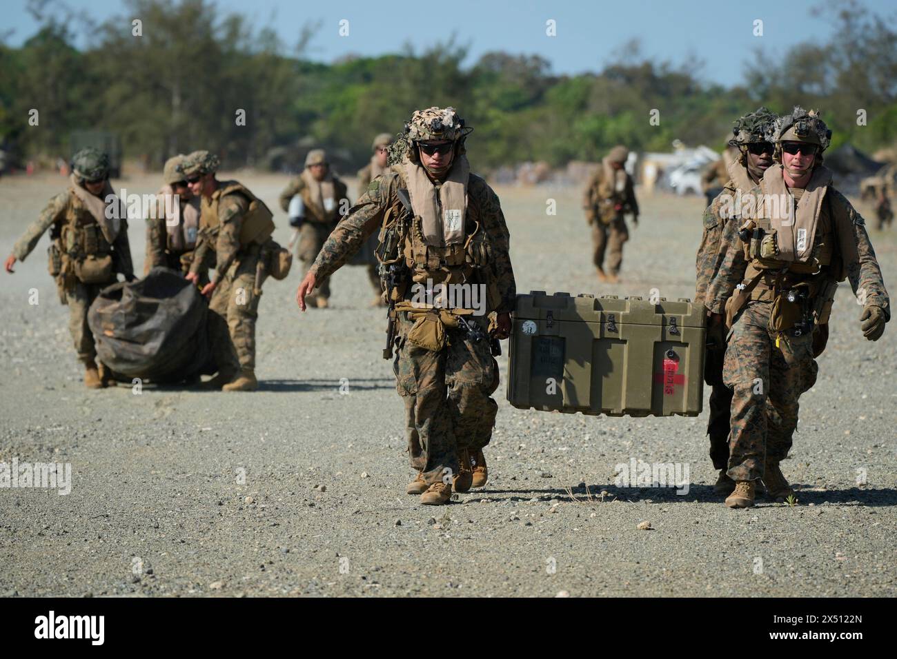 U.S. marines carry equipment at the Paredes Air Station at Pasuquin ...