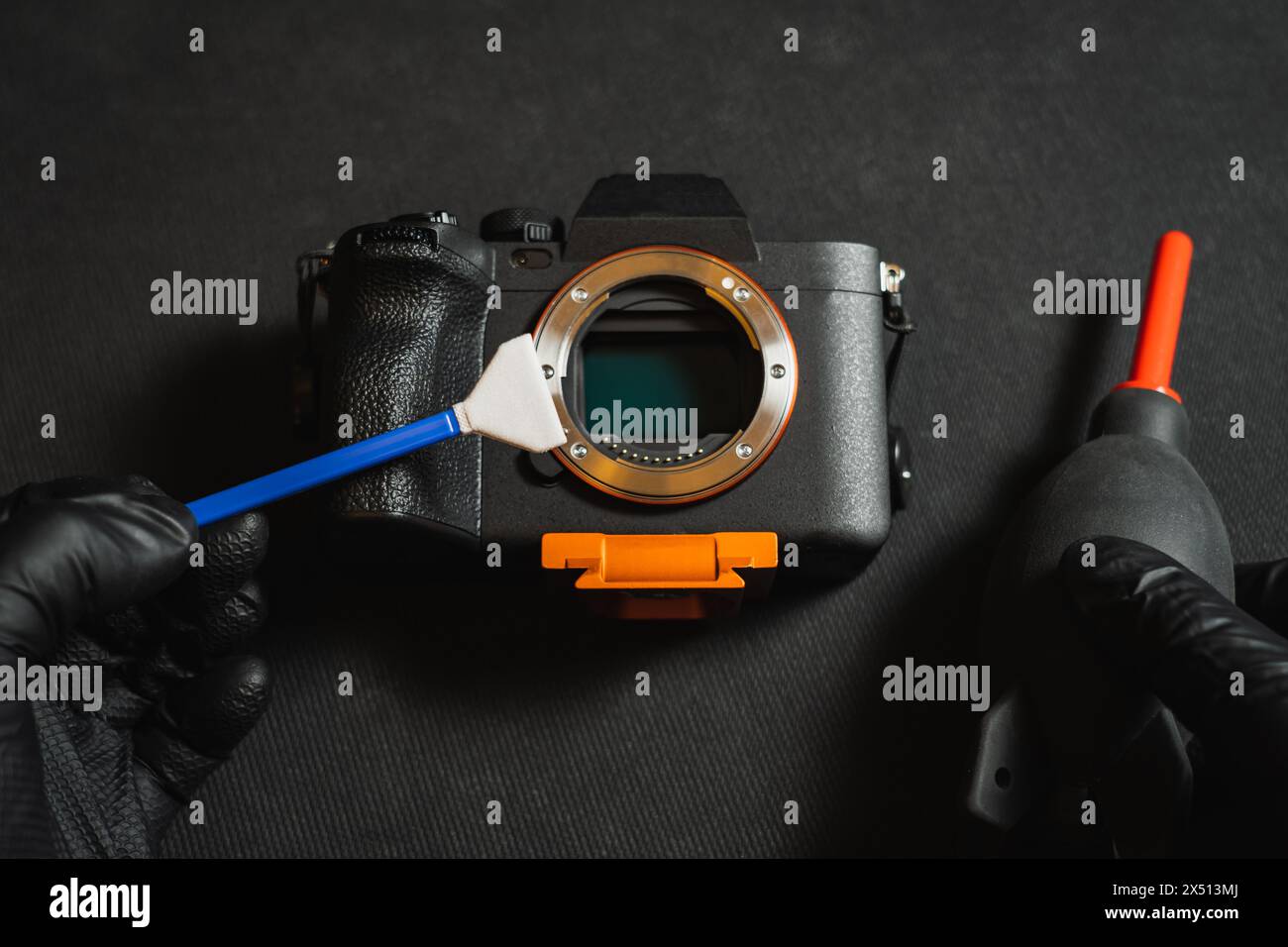 Professional sensor cleaning on a mirrorless camera, close-up photo ...